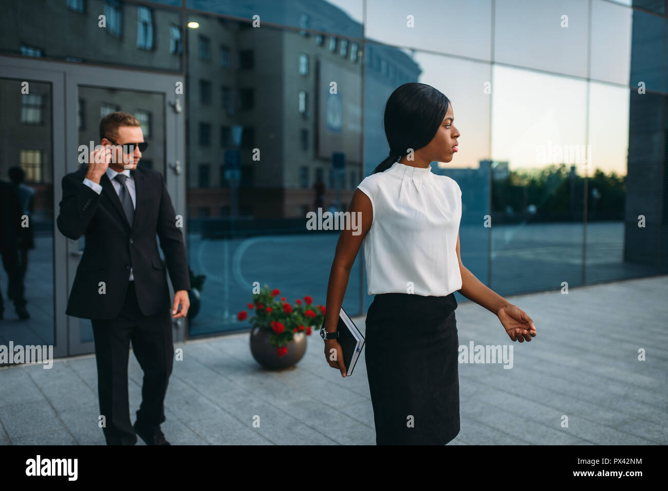 Business woman, bodyguard in suit on background Stock Photo - Alamy