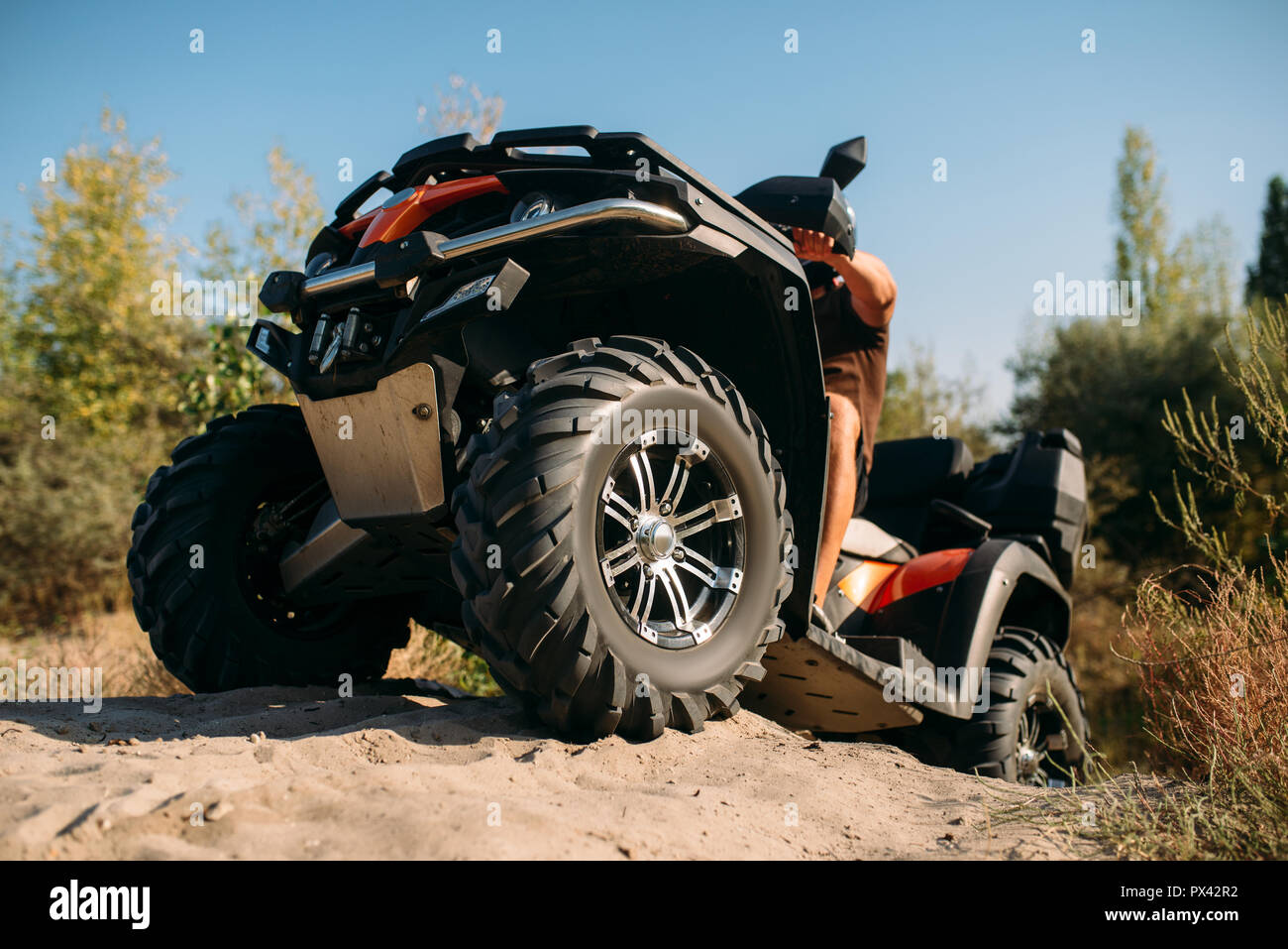 Atv rider climbing the sand mountain in quarry Stock Photo - Alamy