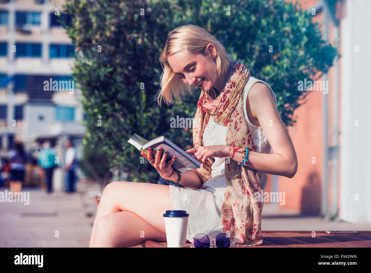 beautiful woman reading a book smiling Stock Photo - Alamy