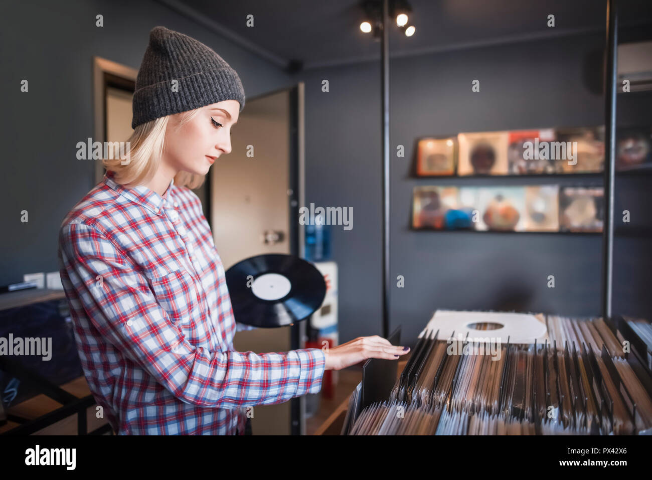 Woman listening vinyl records in hi-res stock photography and images ...