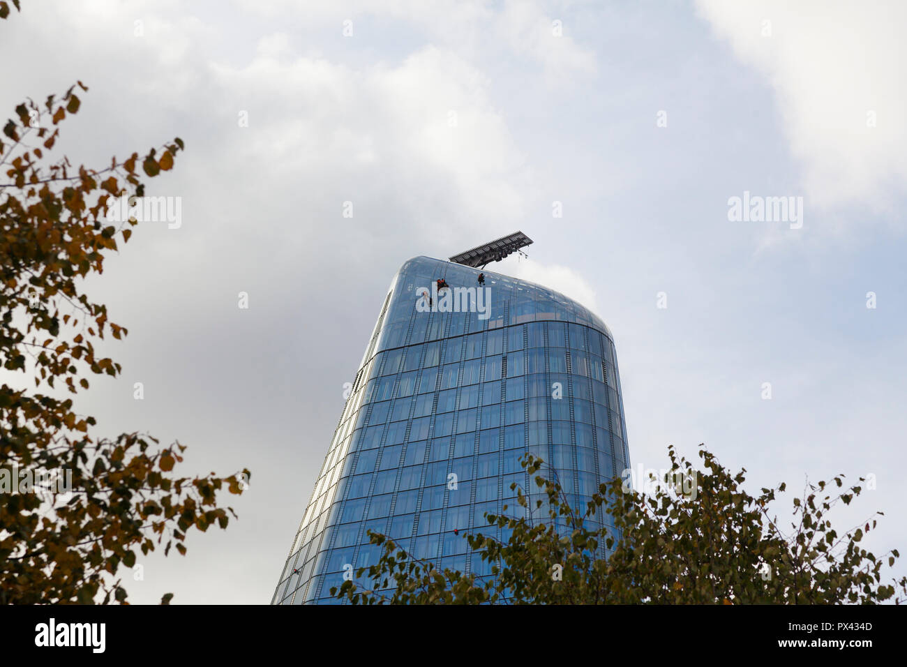 Maintenance operatives or window cleaners working from ropes on the ...