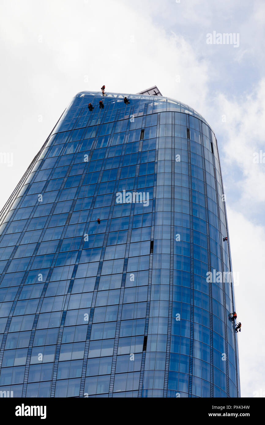 Maintenance operatives or window cleaners working from ropes on the ...