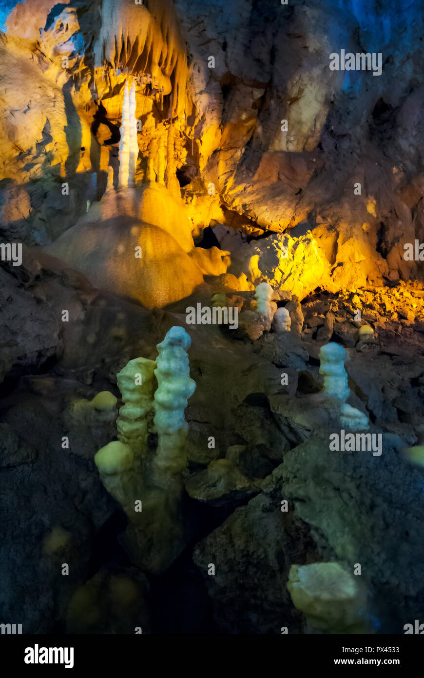 cave with colorful textured walls and stalactites and stalagmite Stock ...