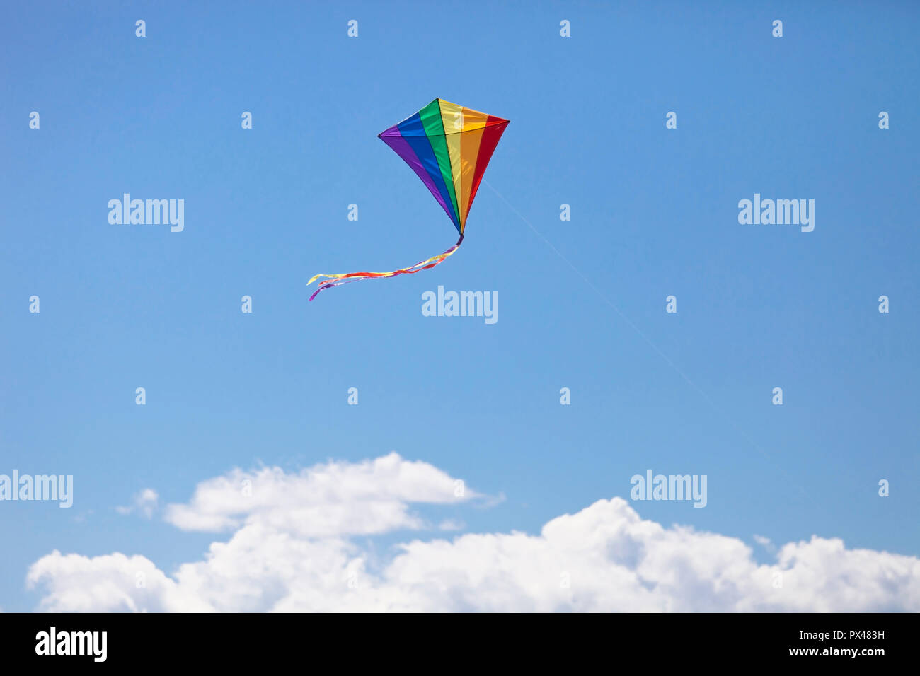 colored kite floating in the sky Stock Photo - Alamy