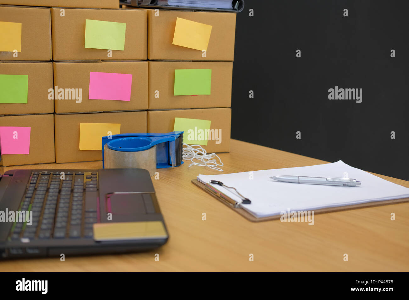 computer & parcel cardboard box at business owner workplace. Online ...
