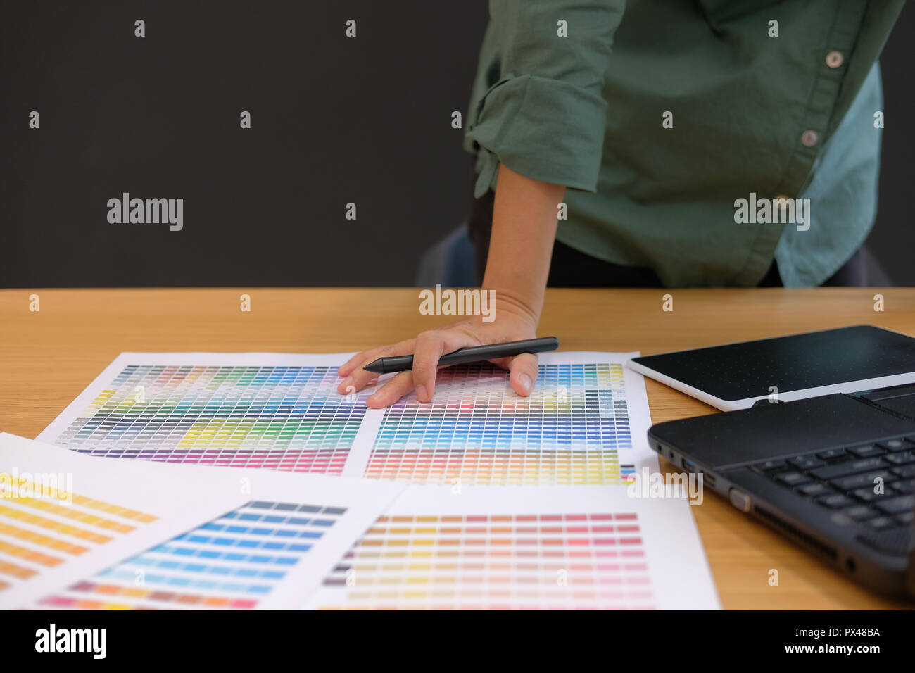graphic interior designer choosing color from swatch sample catalogue ...
