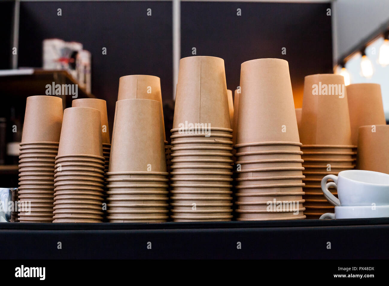 Lot of drinking paper coffee cups in piles. Stack of disposable coffee ...