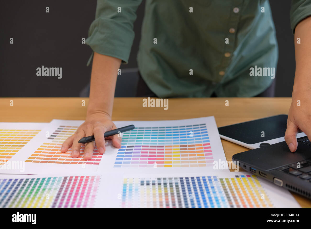graphic interior designer working with computer & choosing color from ...