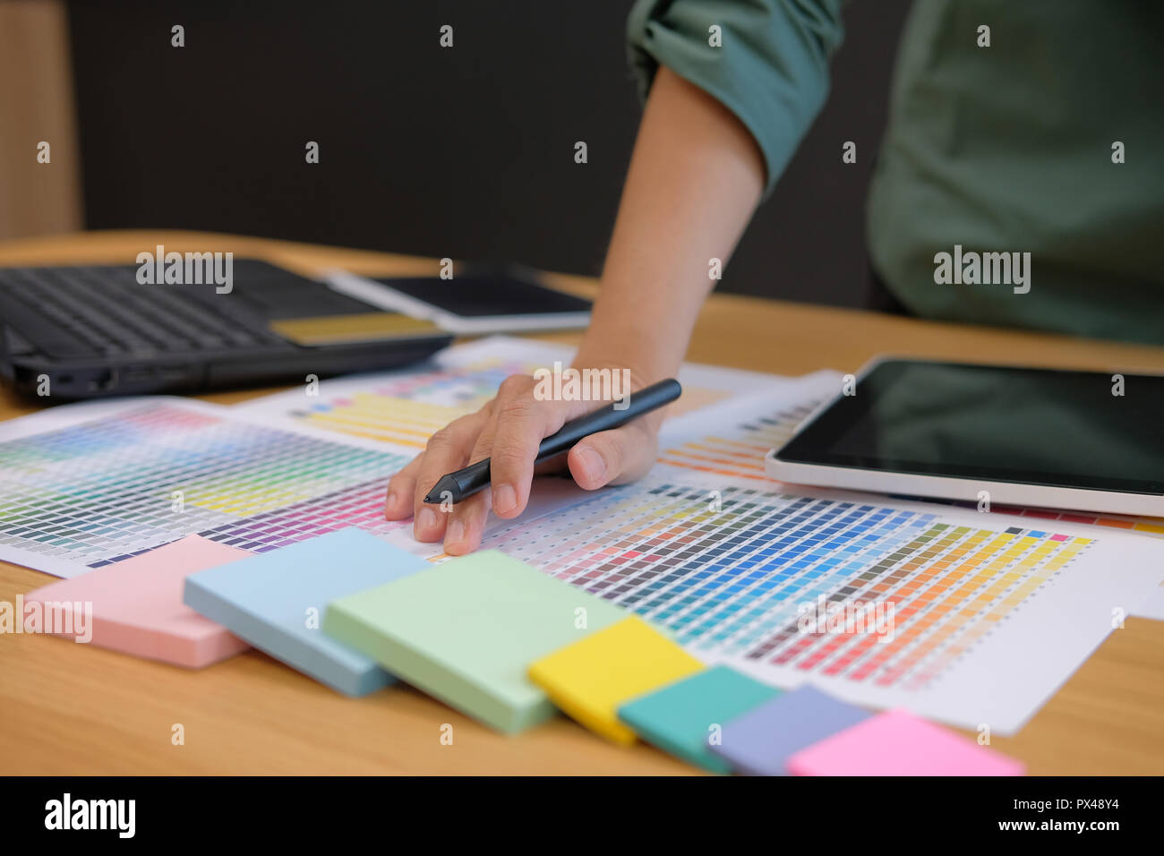 graphic interior designer choosing color from swatch sample catalogue ...