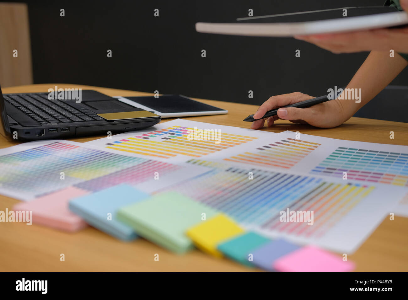 graphic interior designer working with tablet & choosing color from ...