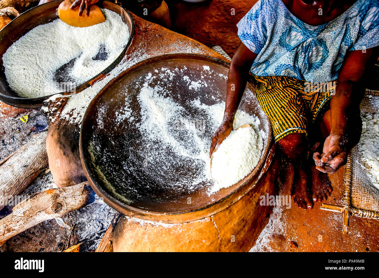 Processing cassava into flour on the outskirts of LomÃ©, Togo Stock ...