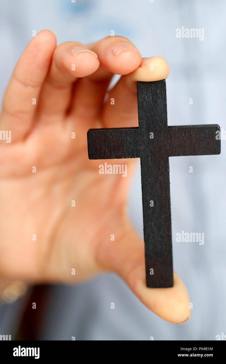 Cross in hand hi-res stock photography and images - Alamy