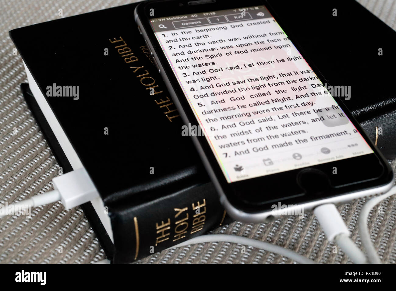 Paper Bible and digital Bible app on smartphone Stock Photo - Alamy