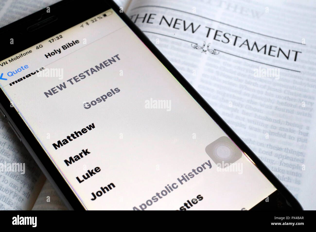 Paper Bible and digital Bible app on smartphone. The New Testament ...
