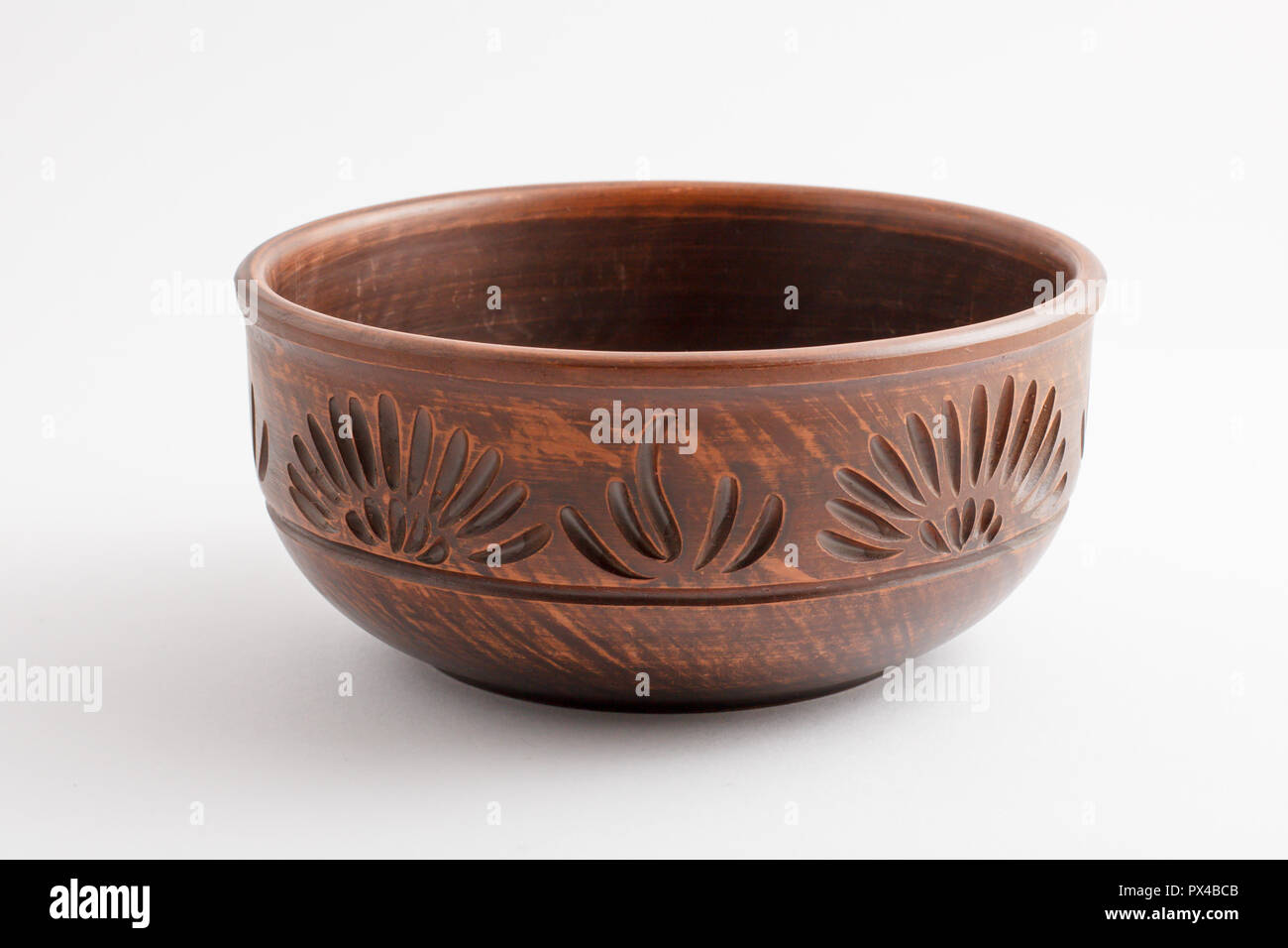 Beautiful brown ceramic bowl with patterns on white background Stock ...