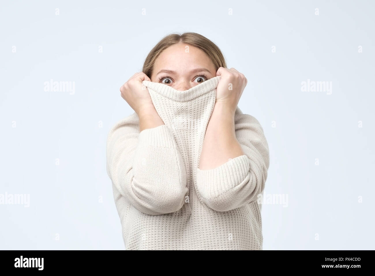 Woman pulling sweater over face hi-res stock photography and images - Alamy