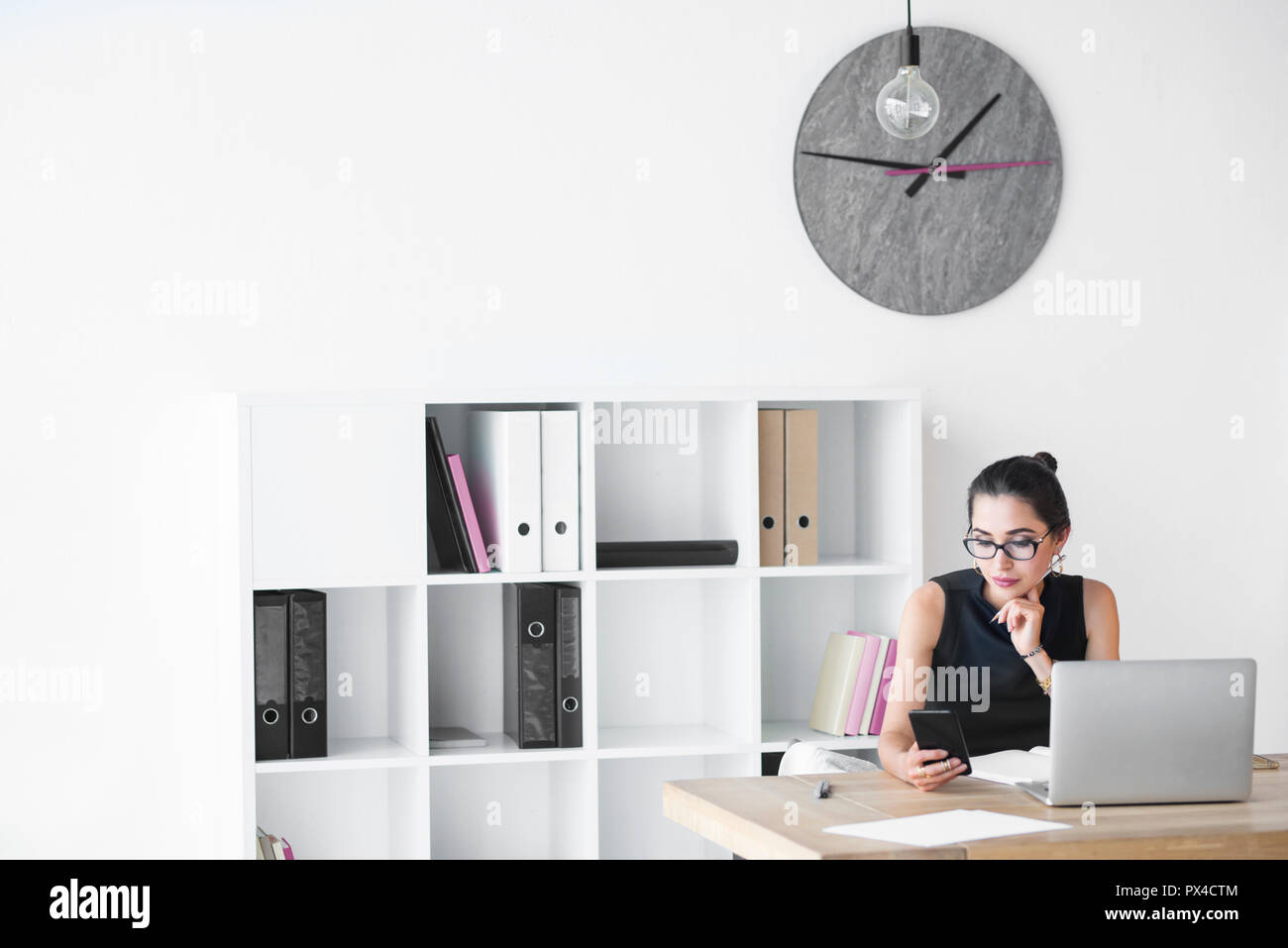 Woman checking clock office hi-res stock photography and images - Alamy