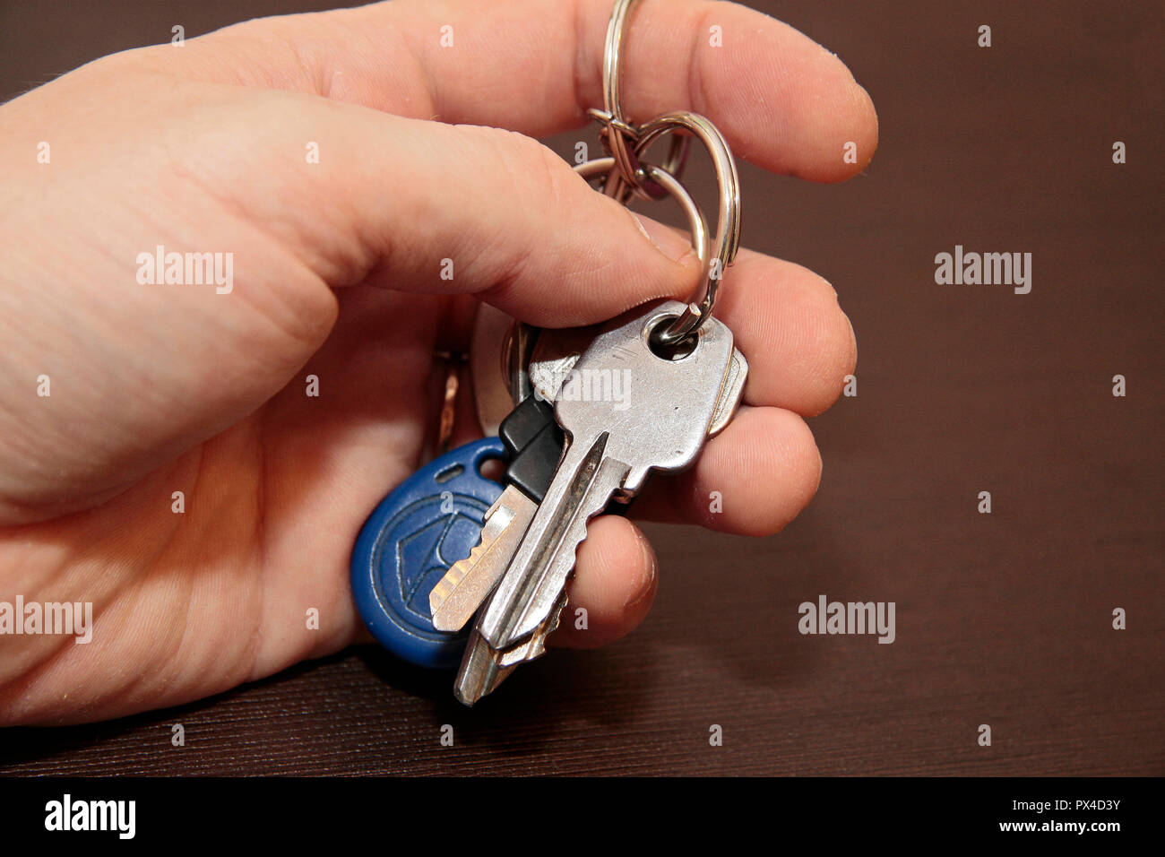 Hand holding bunch keys hi-res stock photography and images - Alamy