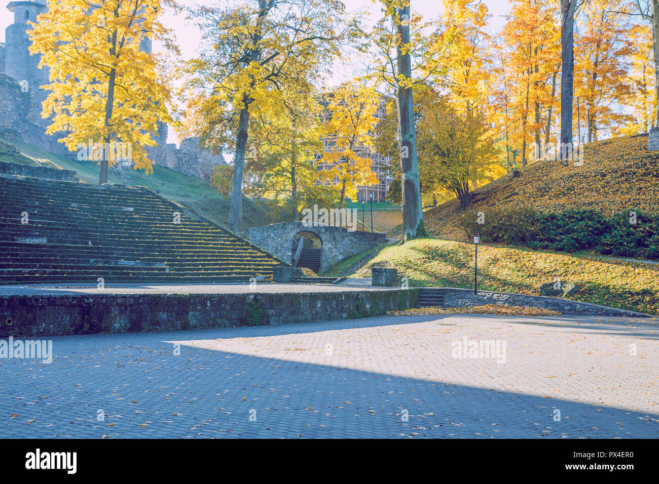 City Cesis, Latvia. Old Casttle park at autumn. Yellow leafs, ruins and ...
