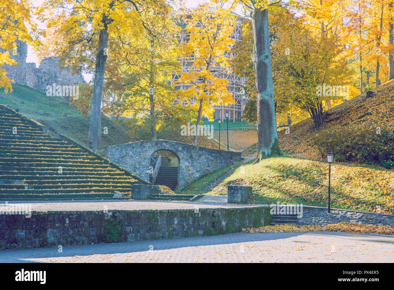 City Cesis, Latvia. Old Casttle park at autumn. Yellow leafs, ruins and ...