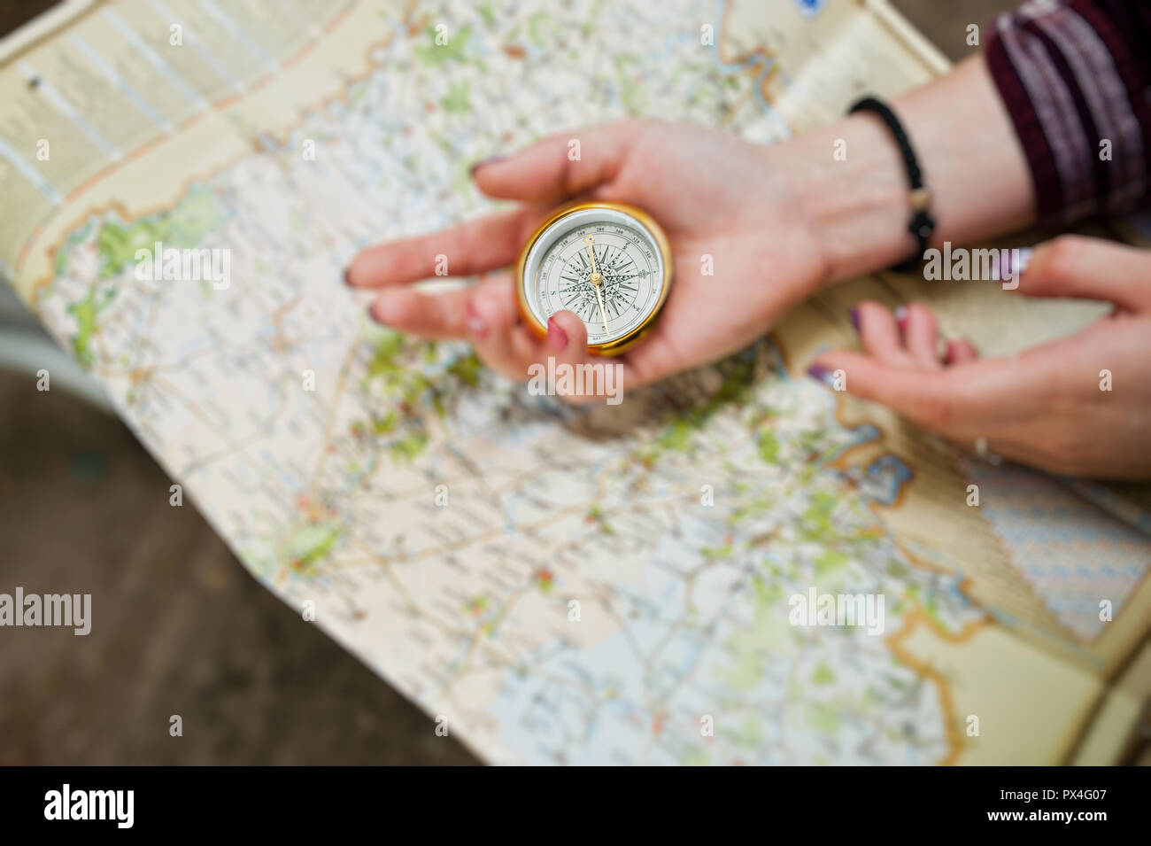 Close-up photo of female hands with compass on a map Stock Photo - Alamy