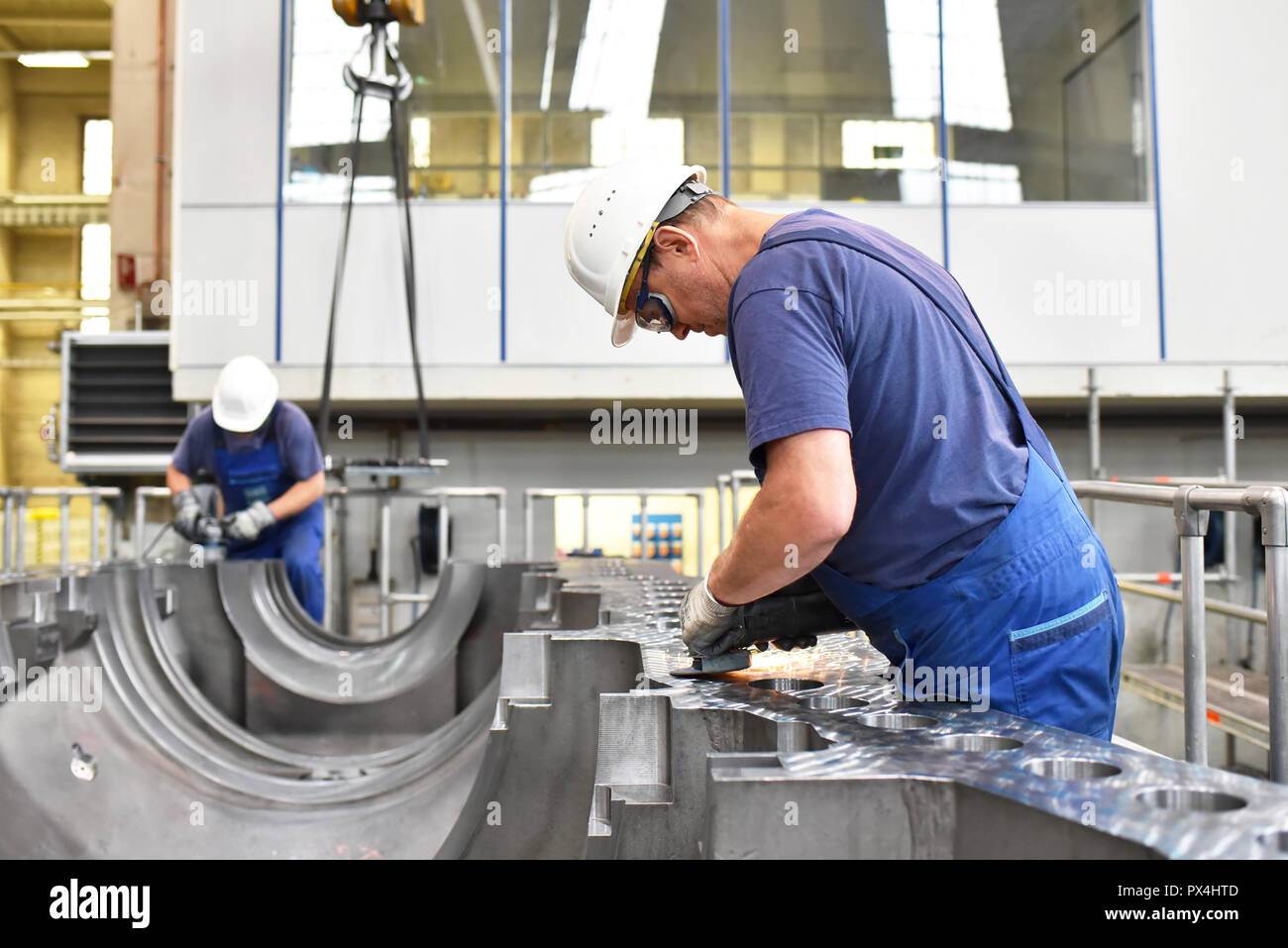 Workers Assembling And Constructing Gas Turbines In A Modern Industrial