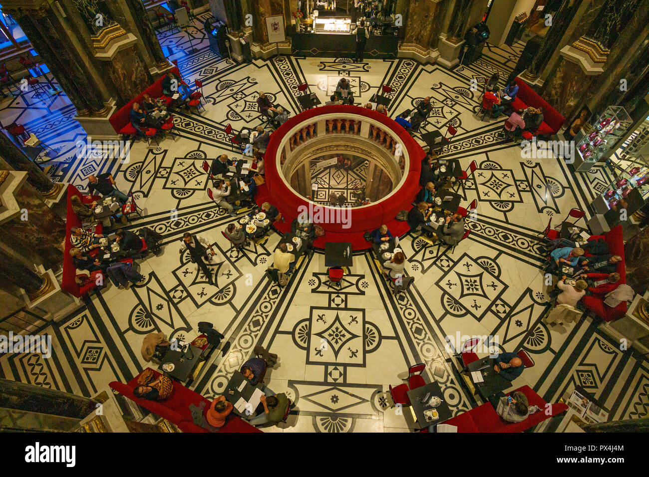 Tourists and visitors relaxing and drinking inside the ancient bar of ...