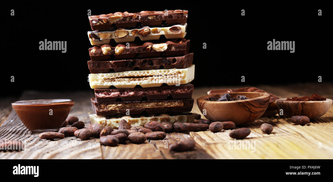 Chocolate bars on table with chocolate tower. Chocolate and nuts Stock ...