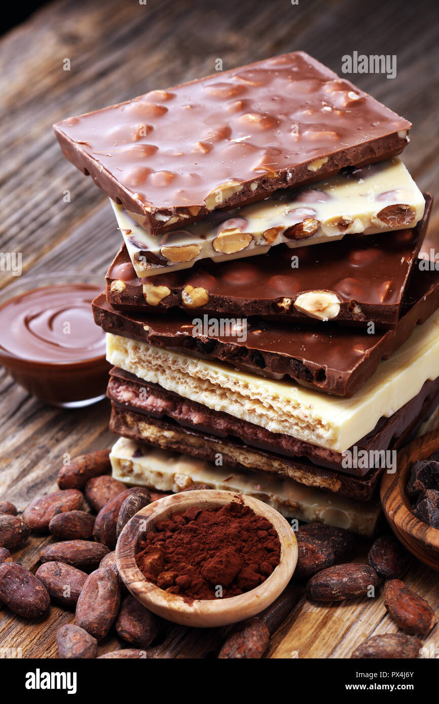 Chocolate bars on table with chocolate tower. Chocolate and nuts Stock ...