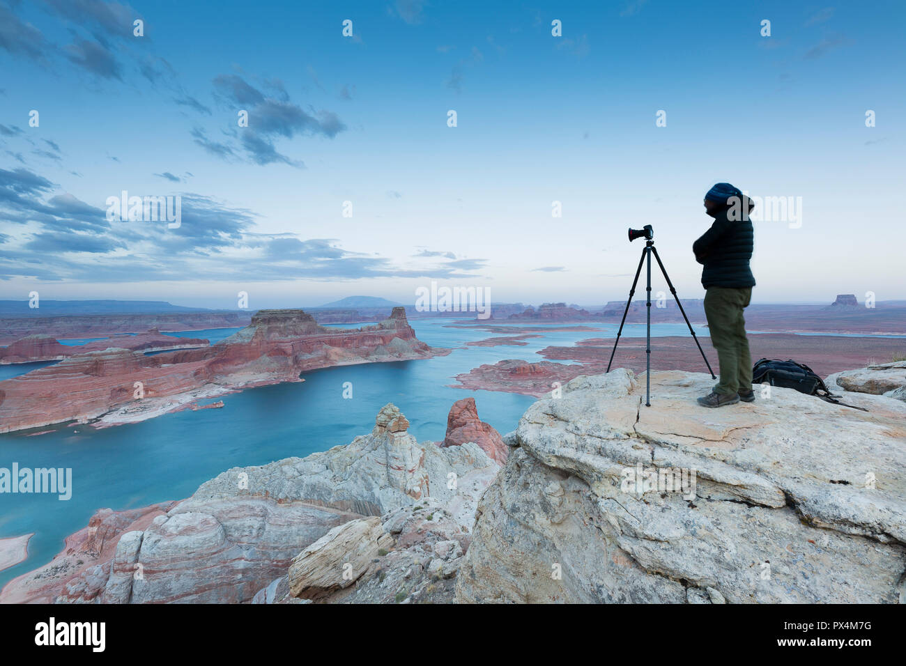 Alstrom Point, AZ, USA. A landscape photographer stands with his camera ...