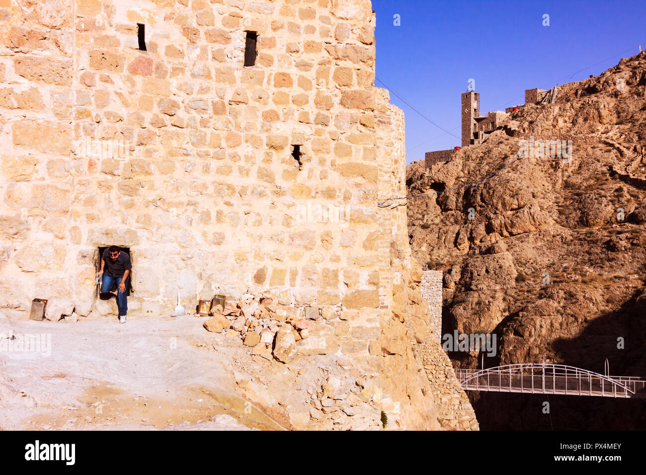 Al-Nabek, Rif Dimashq, Syria : A man goes through a narrow exit door at ...