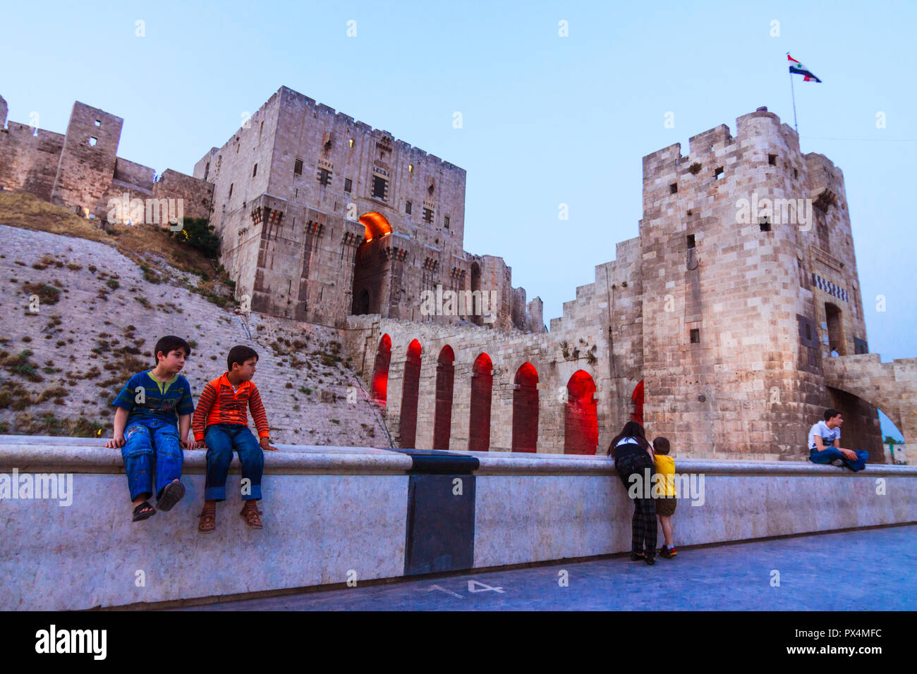 Aleppo, Aleppo Governorate, Syria : People sit outside the Citadel of ...