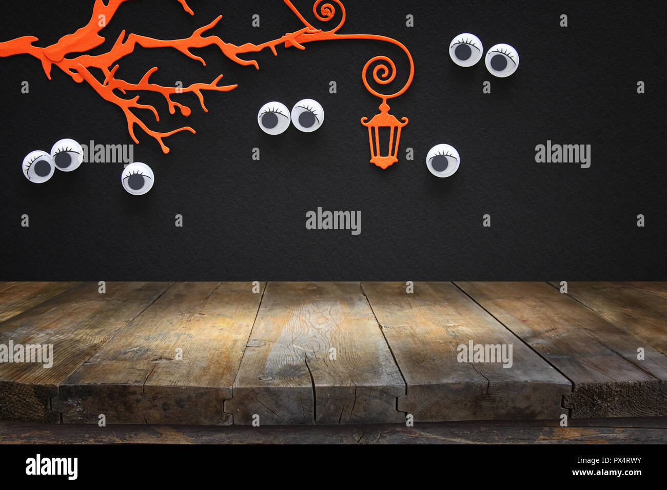 Halloween holiday concept. Empty rustic table in front of haunted ...