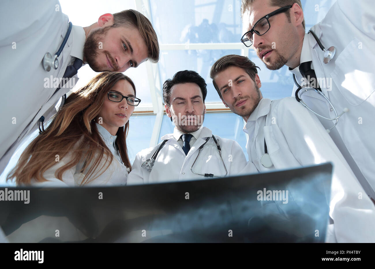 doctors colleagues look at the x-ray of the patient . the concept of ...