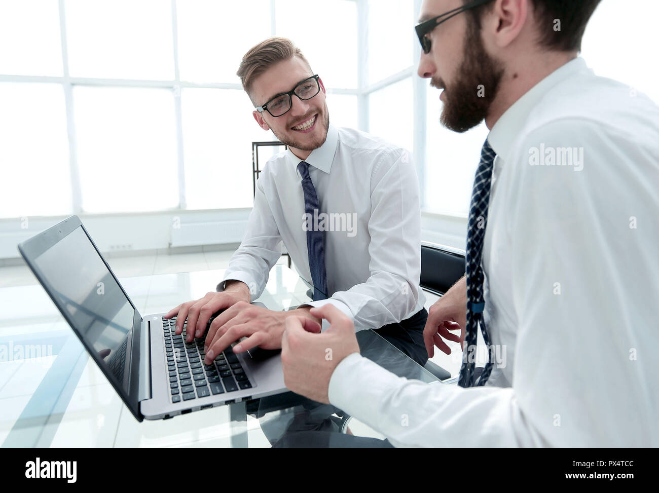 smiling employees at the Desk in the office.photo with copy space Stock ...
