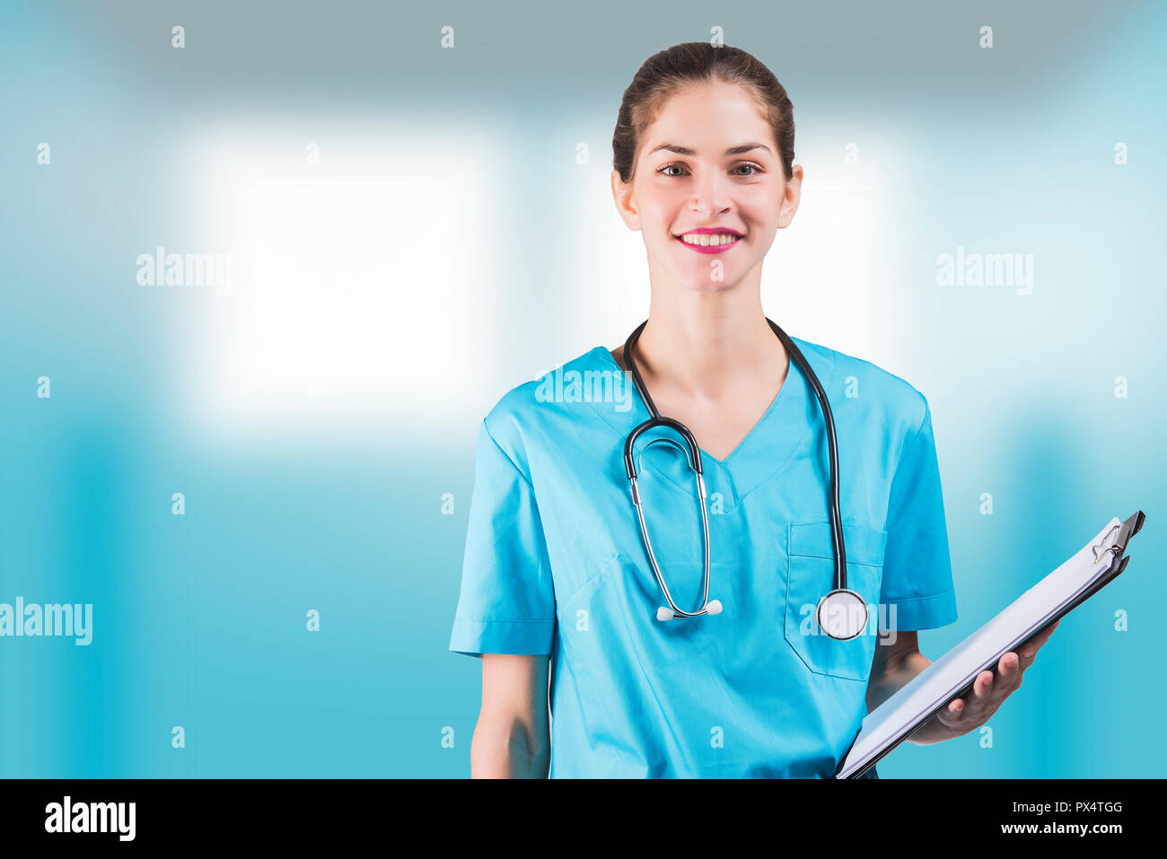 beautiful woman nurse or doctor is holding a notepad board with copy ...