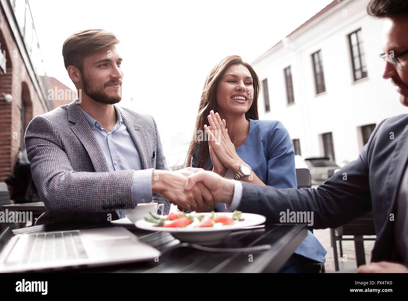 business partners greeting each other with a handshake. informal ...