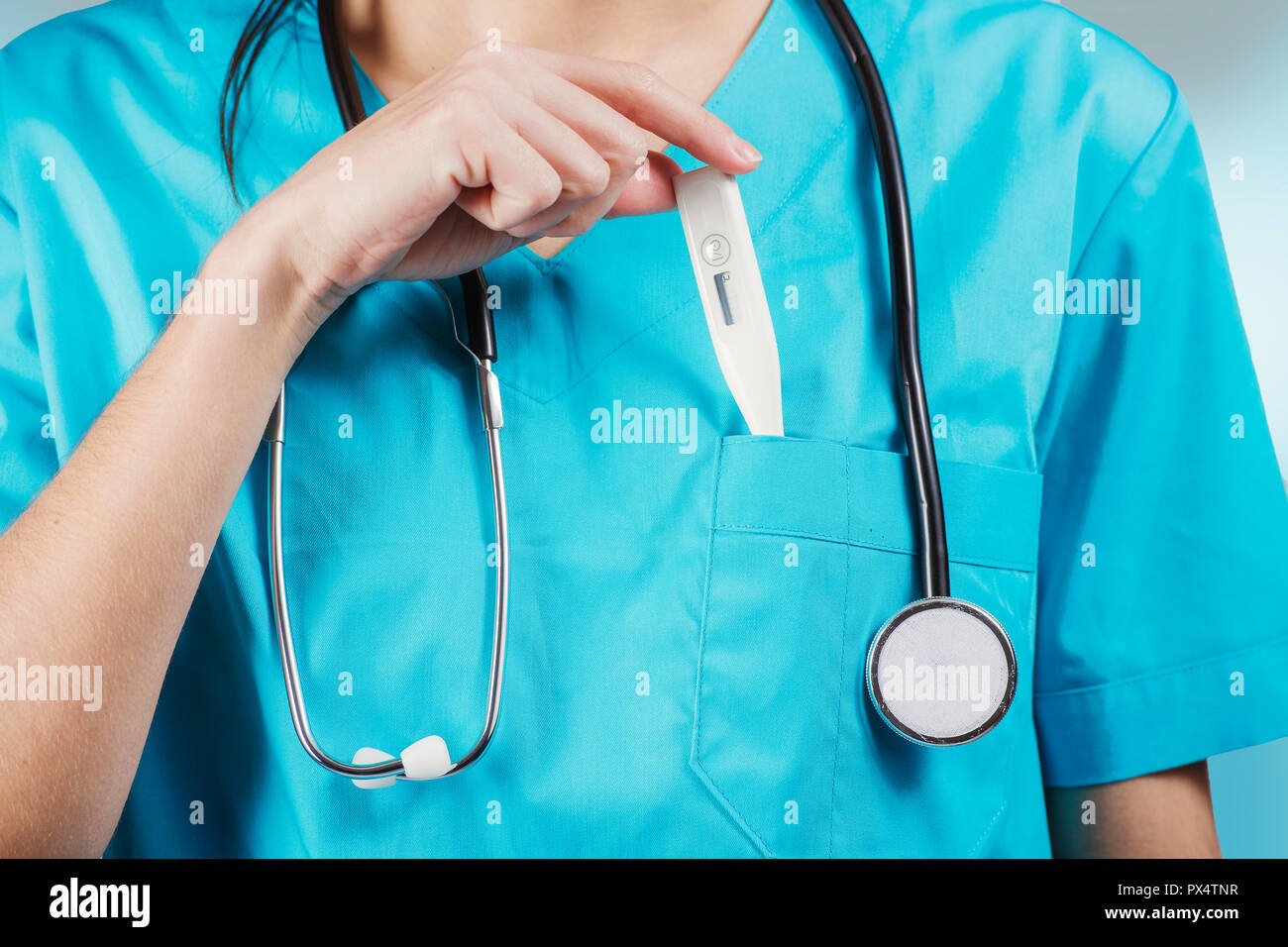 woman nurse or doctor close up while putting thermometer inside chest ...