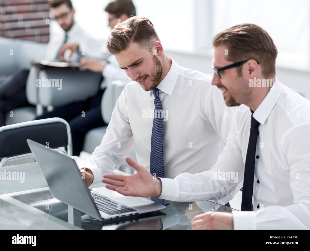 colleagues discussing current information at the desktop.the concept of ...