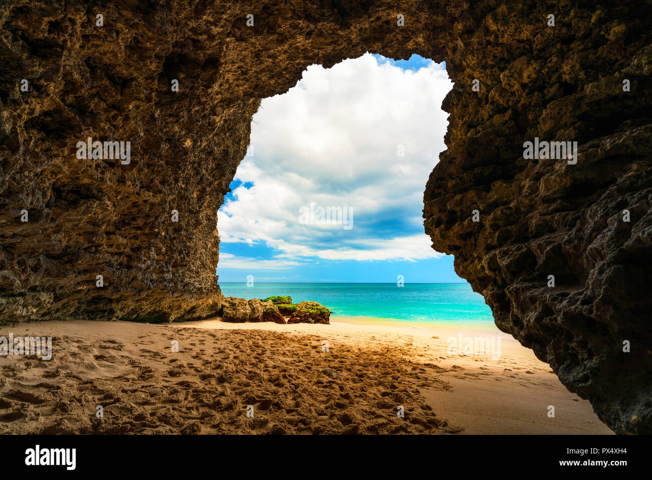 Amazing view from cave to the tropical beach with azure sea, blue sky ...