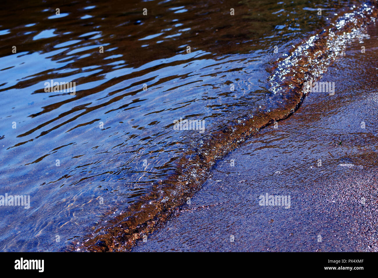 Wet sand and small wave on sandy beach. Close up horizontal image Stock ...
