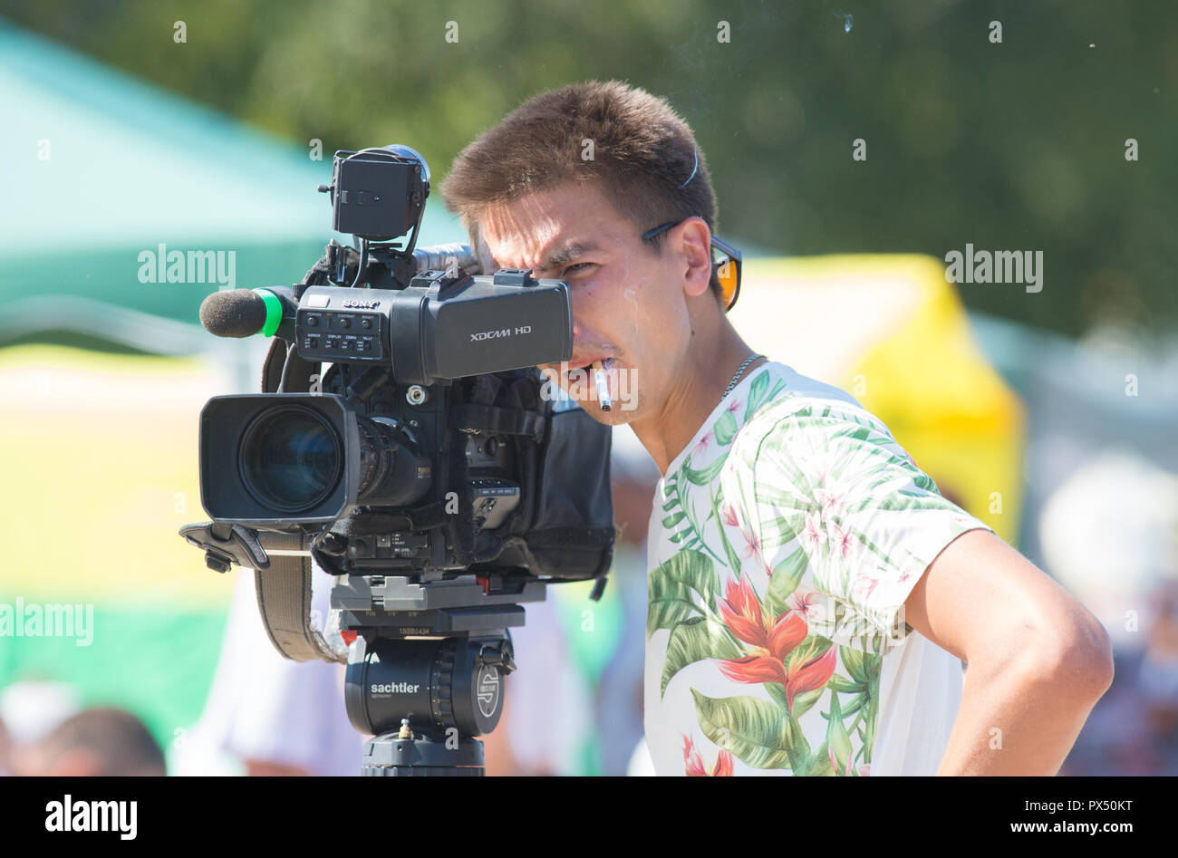20 August 2018, Krasnovidovo, Russia - a man stay near the camera and ...