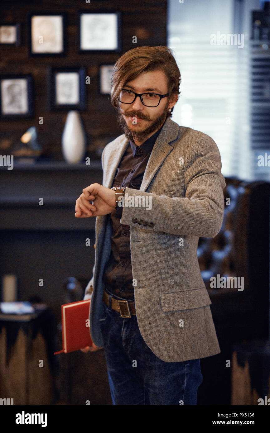Businessman watching the time on his watch Stock Photo - Alamy