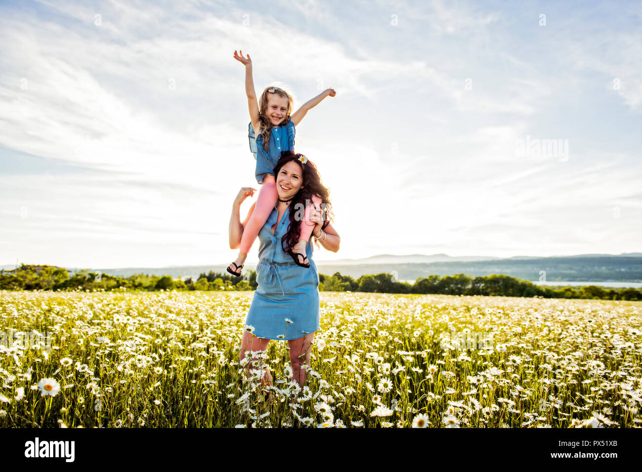 Mother spending time with daughter during the sunset Stock Photo - Alamy