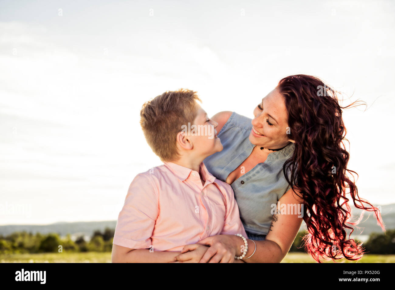 Mother spending time with son during the sunset Stock Photo - Alamy