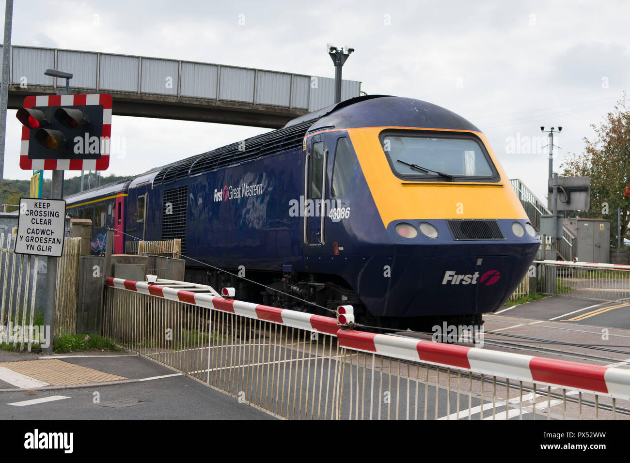 A First Great Western (FGW) train seen on a level crossing in Bridgend ...