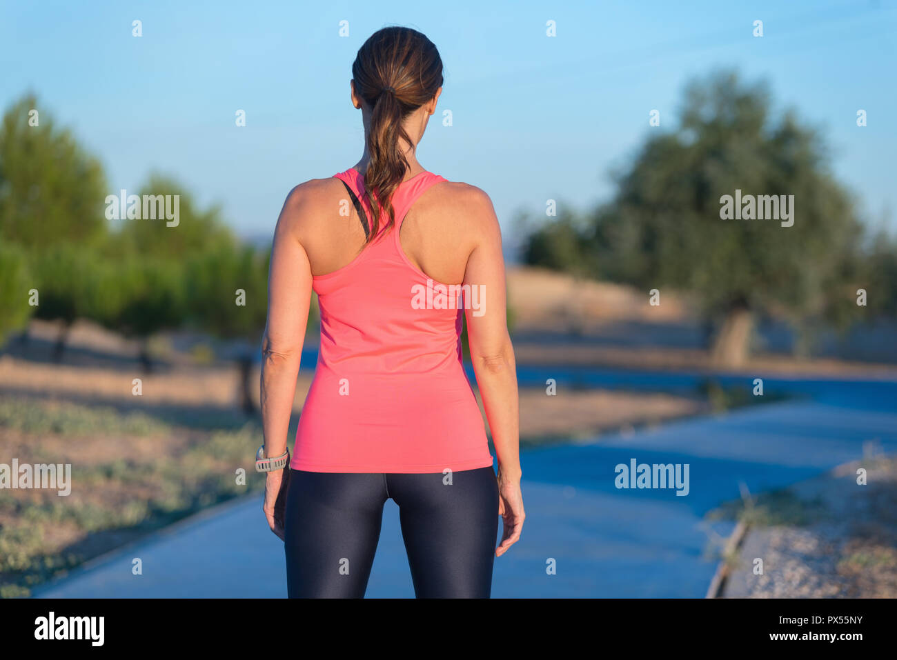Portrait of beautiful woman ready to start running, back view Stock ...