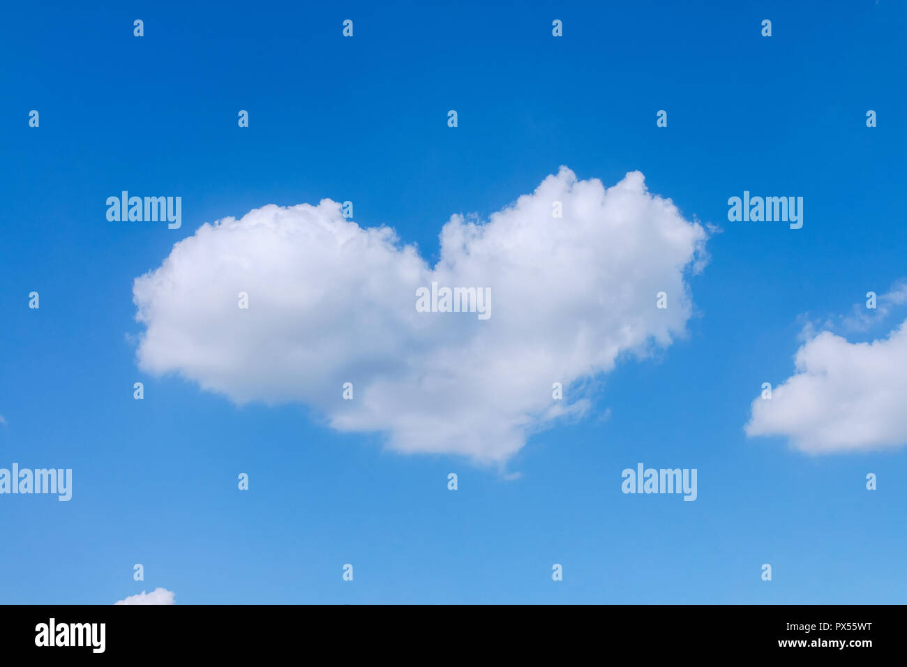 One white heart shaped cloud floating in the sky Stock Photo - Alamy