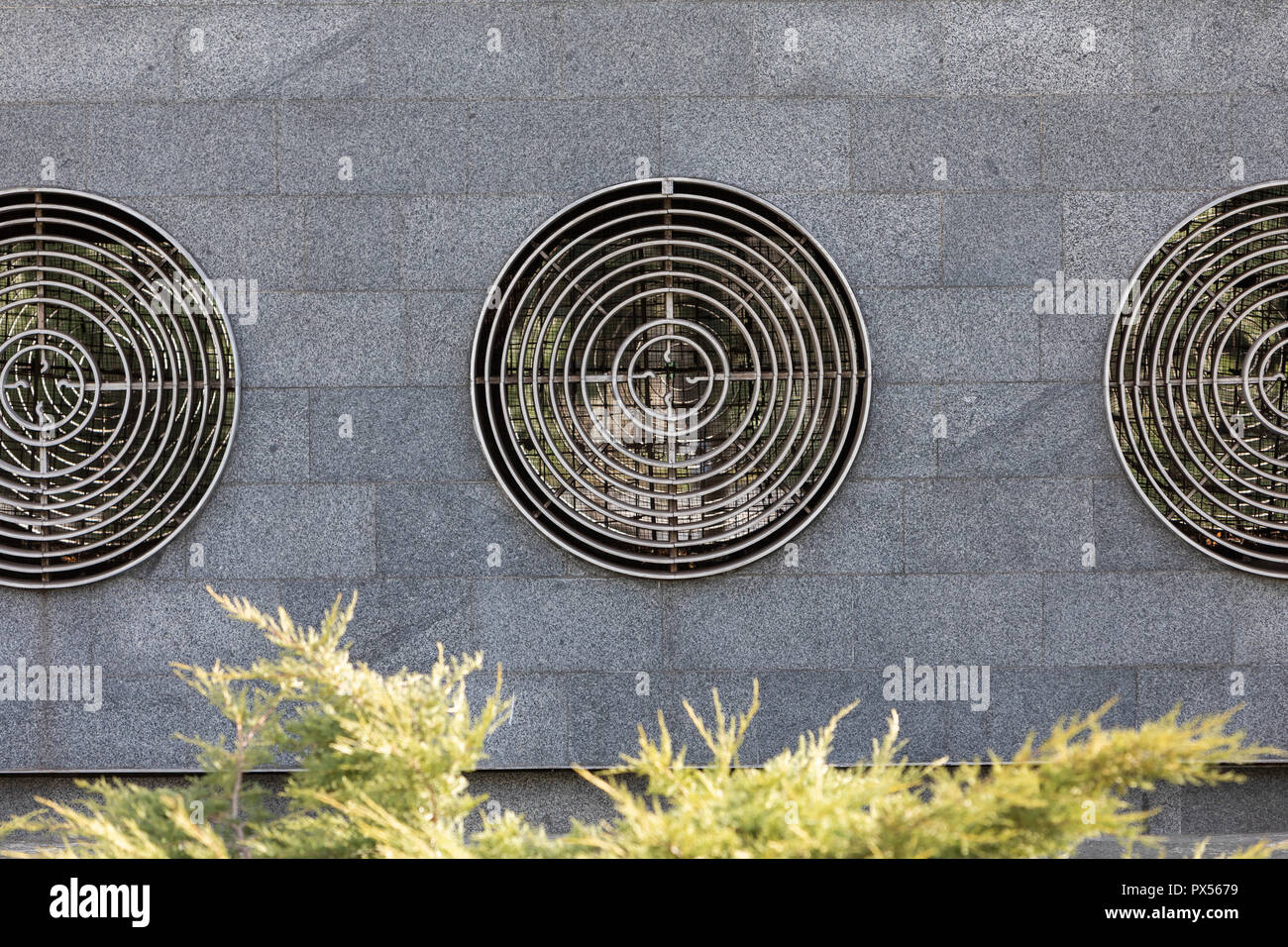 Round windows with metal bars in a concrete wall Stock Photo - Alamy