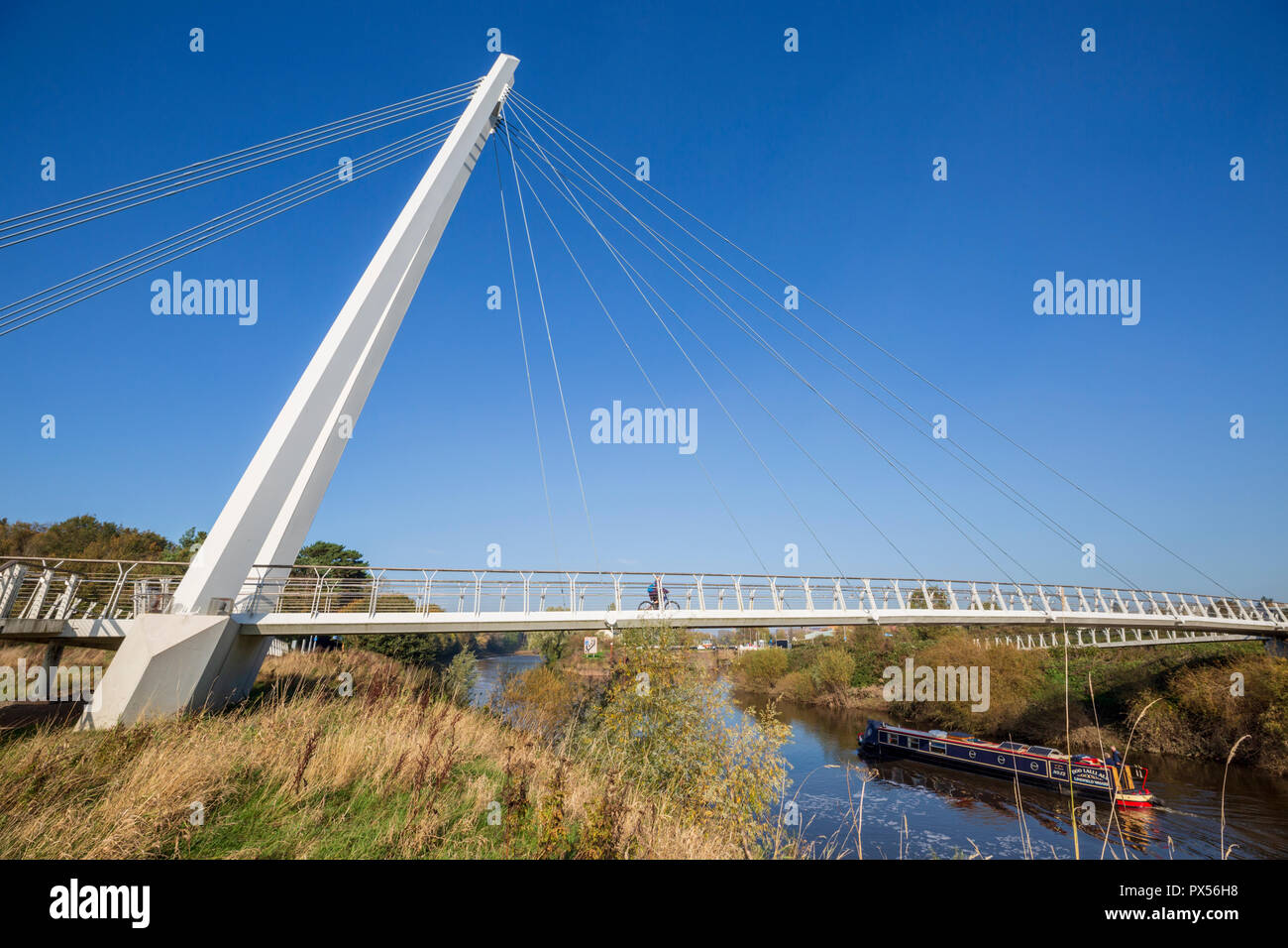 Canal barge traveling along the River Severn passing under Diglis Foot ...
